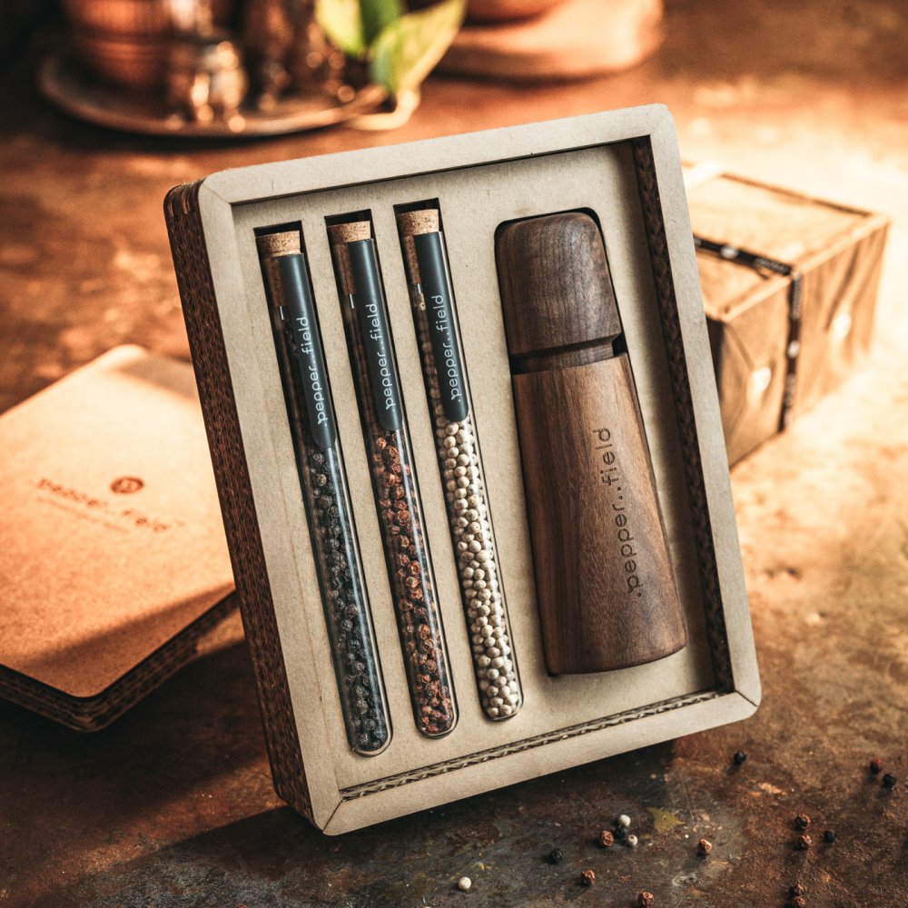 Scandinavian grinder with a set of tubes filled with Kampot pepper in a ...