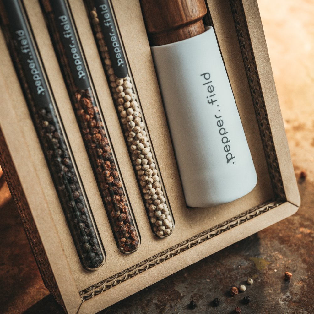 Scandinavian grinder with a set of tubes filled with Kampot pepper in a ...
